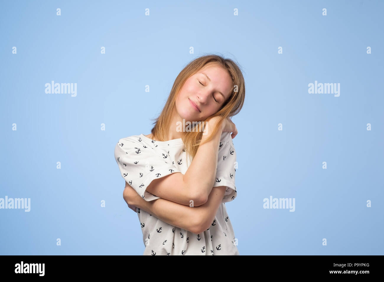 Happy european woman hugging herself with natural emotional enjoying ...