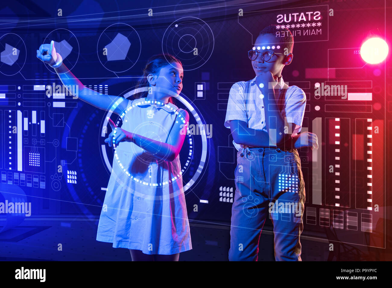 Smart girl turning to a boy and touching the screen Stock Photo - Alamy