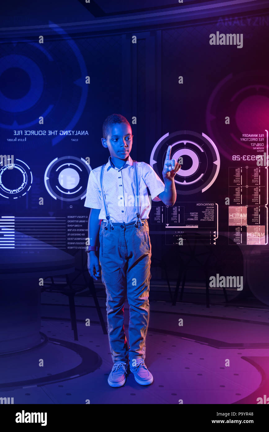 Calm boy standing alone and doing homework Stock Photo - Alamy