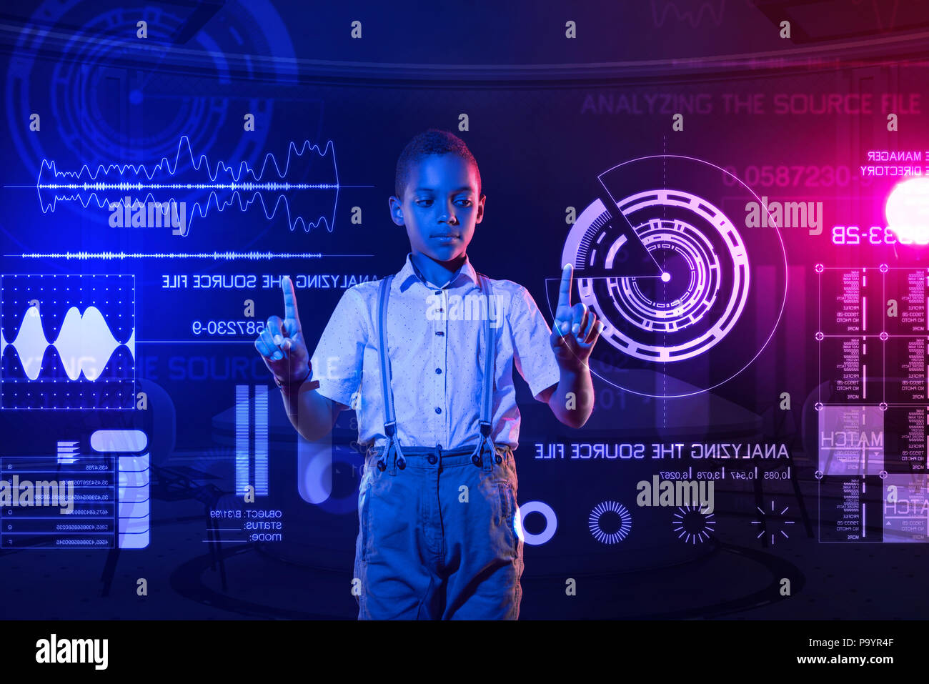 Clever boy comparing security systems and touching the screen Stock ...