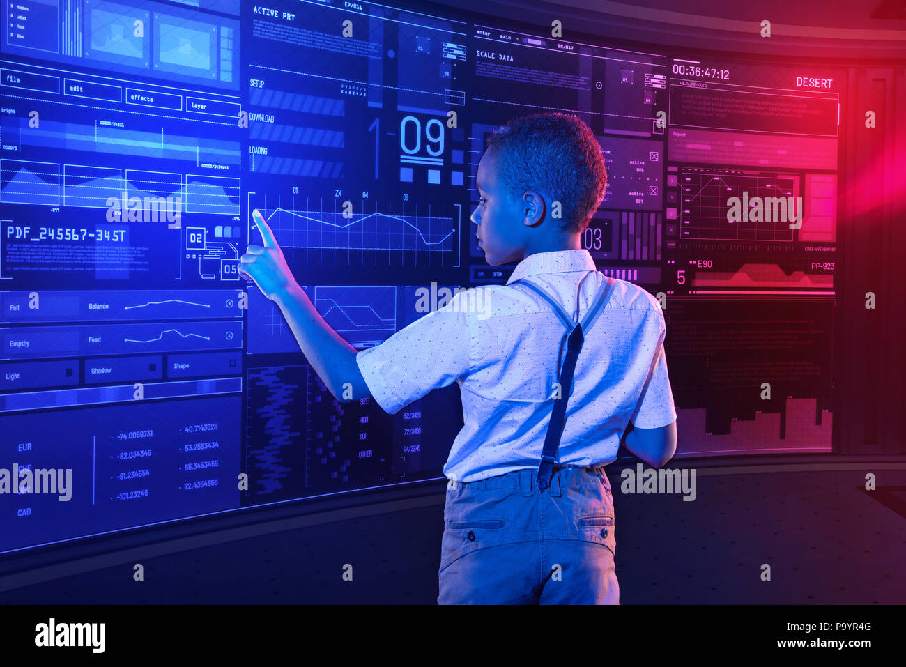 Calm boy touching the screen while checking the information Stock Photo ...