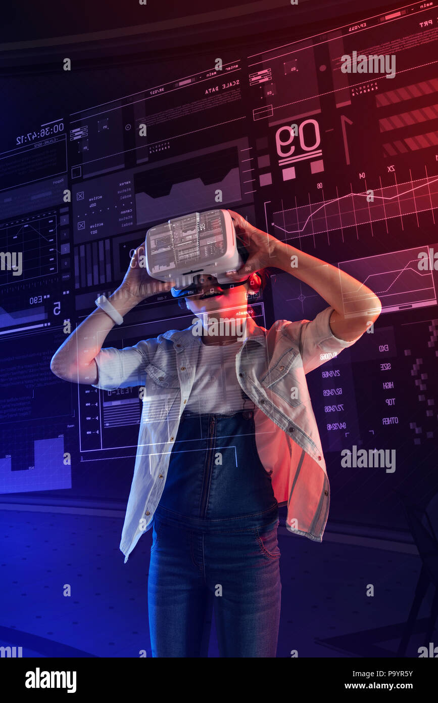 Happy child wearing virtual reality device and looking glad Stock Photo ...