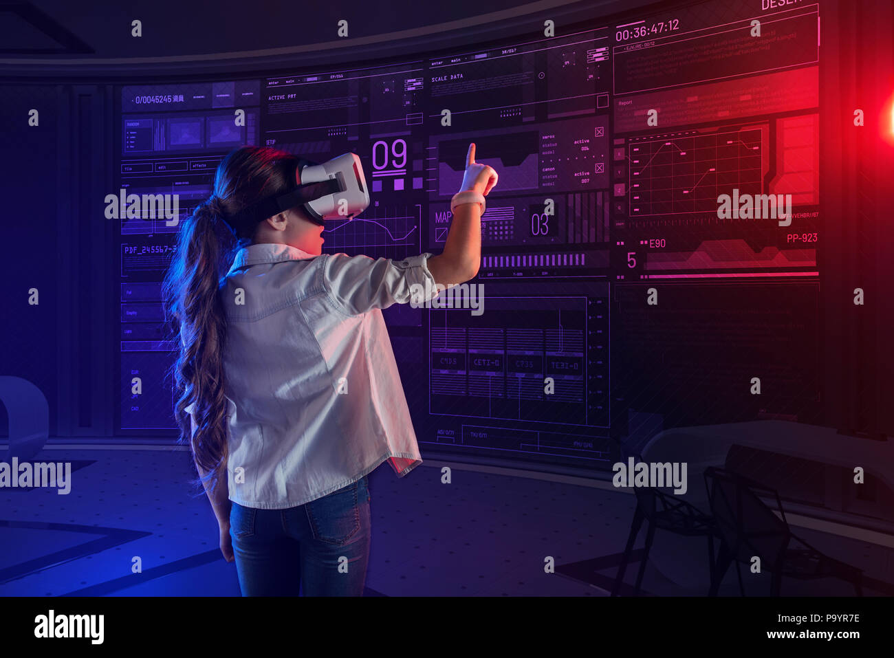 Smart kid touching the screen and exploring virtual reality Stock Photo ...
