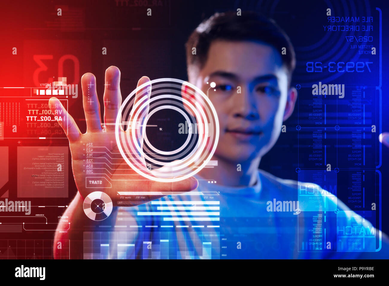 Clever student scanning his hand while using a futuristic device Stock ...