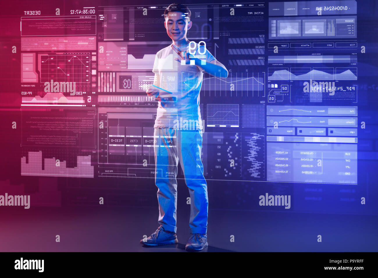 Cheerful software developer standing opposite screen transparent device ...