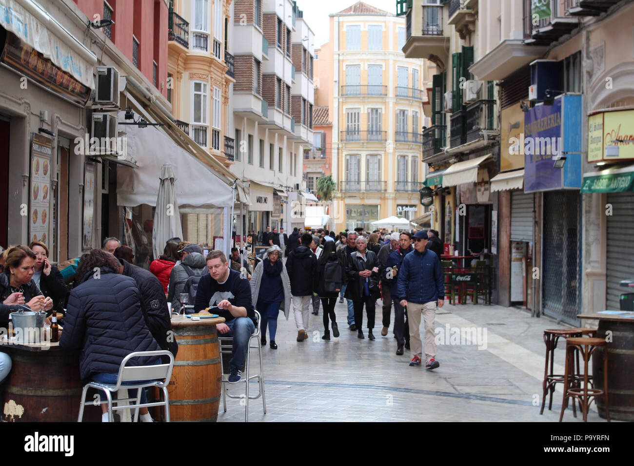Busy pedestrian street in Málaga, Spain, with people dining outdoors ...