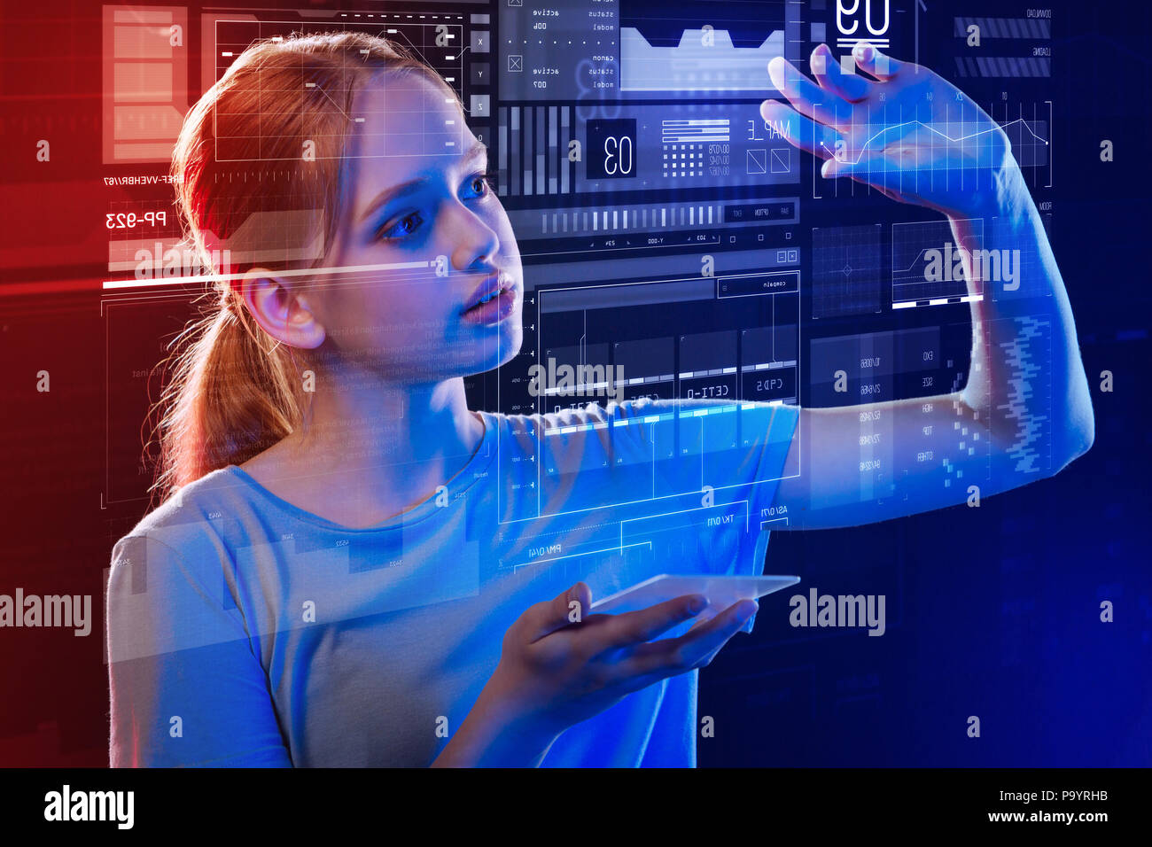 Calm girl holding a smartphone and making a hologram Stock Photo - Alamy