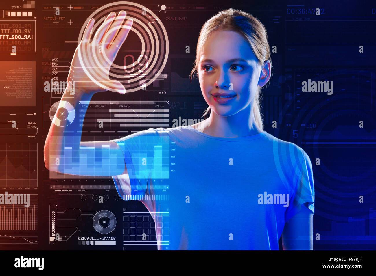 Smiling girl using a security system and touching the screen Stock ...