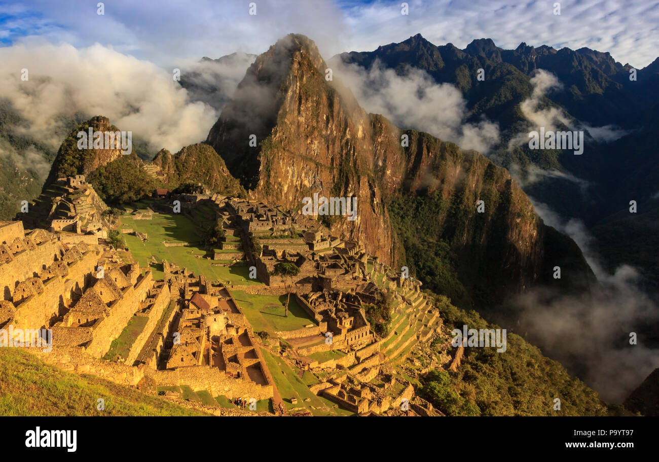 Machu Picchu at sunrise with clouds Stock Photo - Alamy