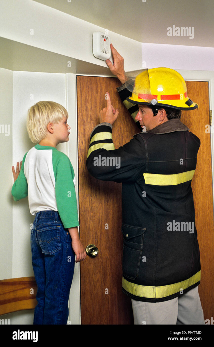 MAN FIREFIGHTER IN PROTECTIVE HELMET AND TURNOUT JACKET INSTRUCTING ...