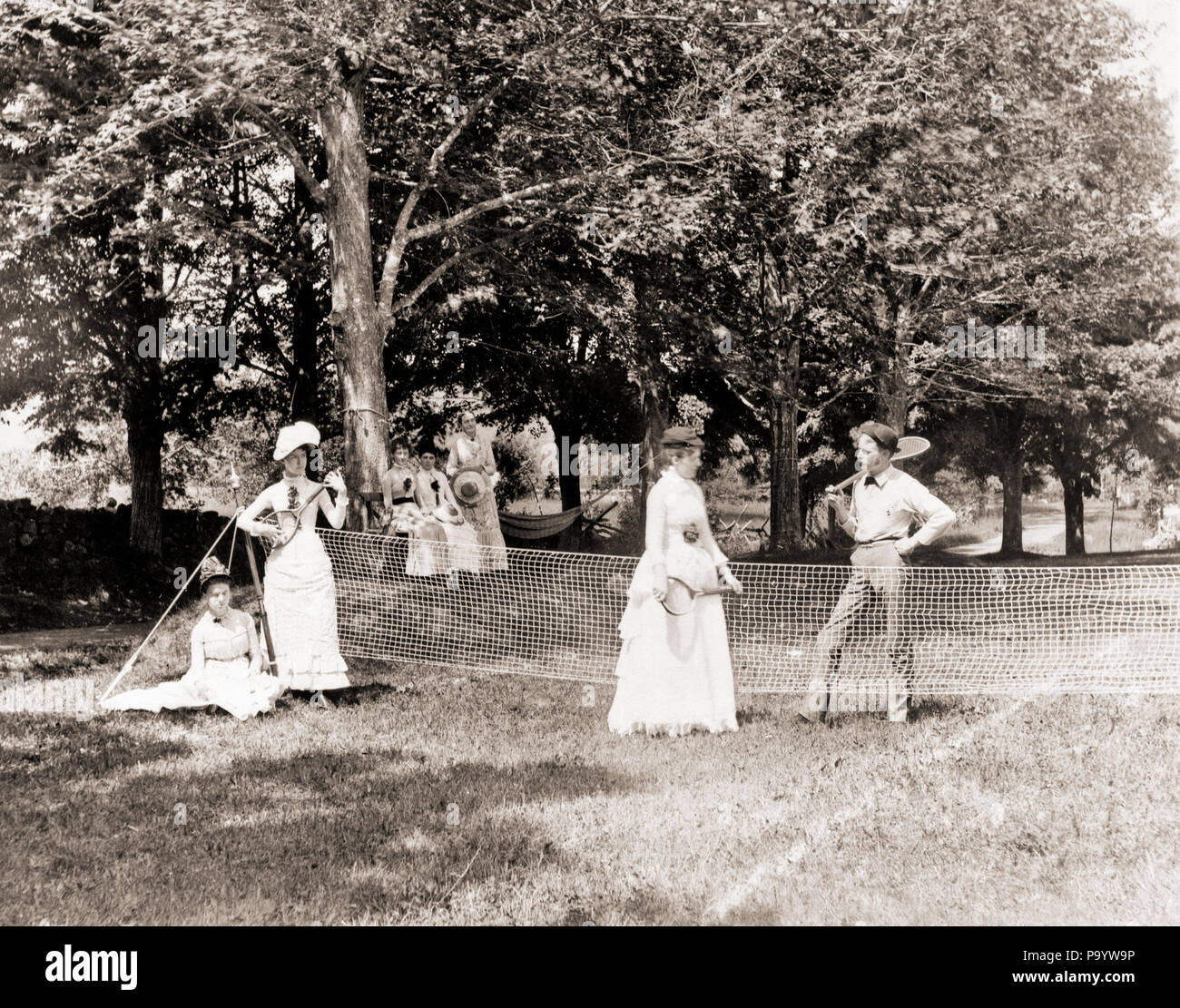 1890s 1900s GROUP OF MEN AND WOMEN GATHERED AROUND GRASS TENNIS COURT ...