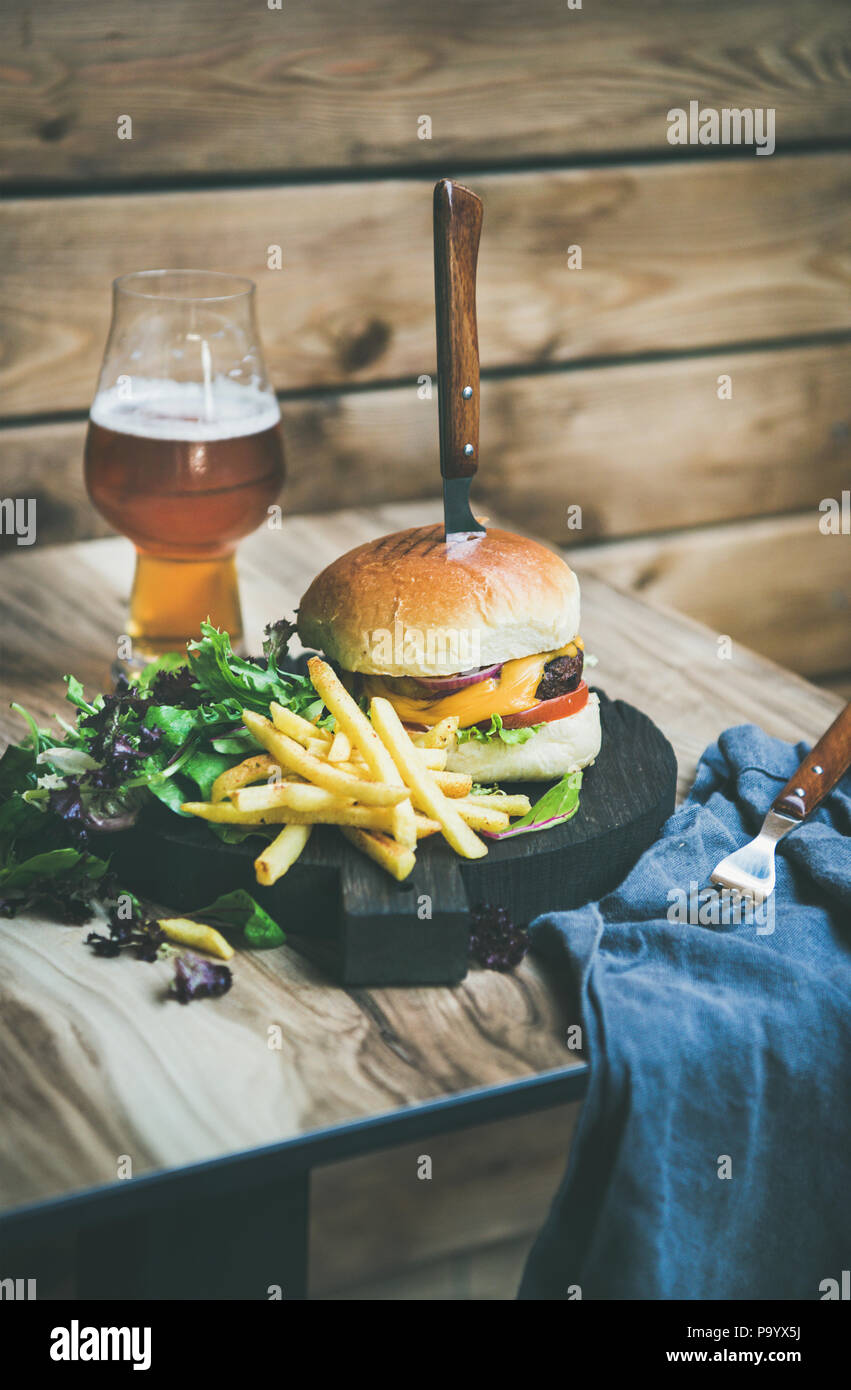 Classic burger dinner with glass of beer and french fries Stock Photo ...