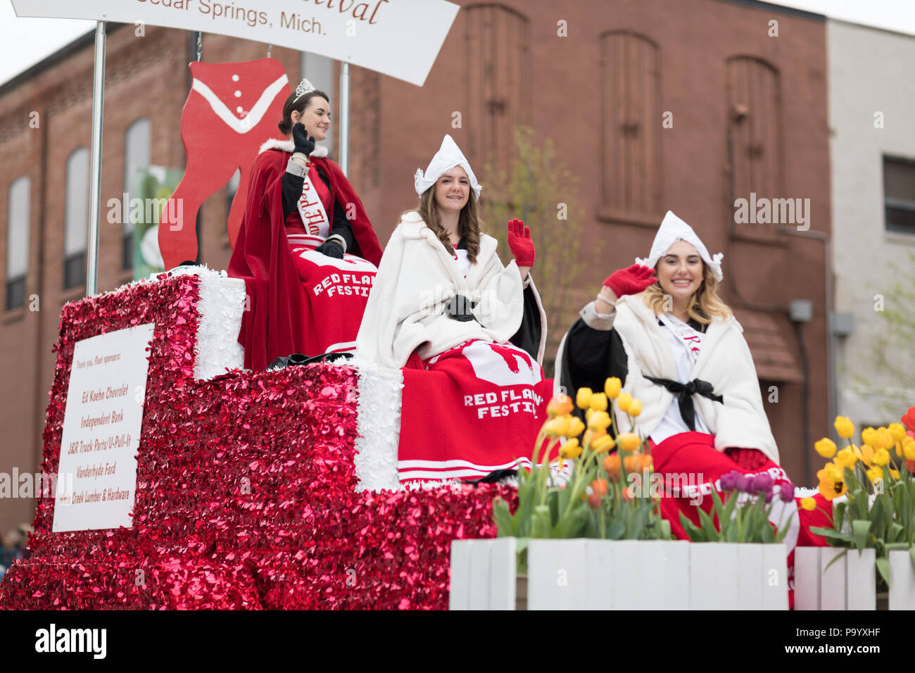 Holland, Michigan, USA - May 12, 2018 Beauty queens on a red float ...