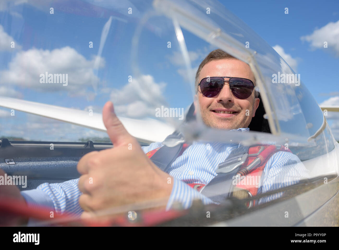 glider pilot smiling and showing thumbs up Stock Photo - Alamy