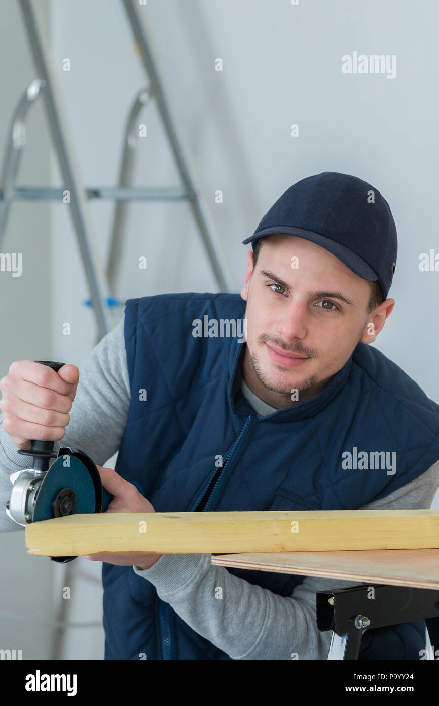 Professional carpenter using grinding machine hi-res stock photography ...
