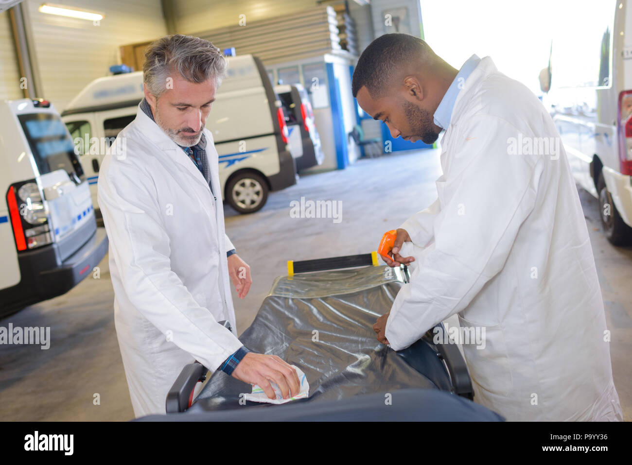 doctors cleaning bed for ambulance Stock Photo - Alamy