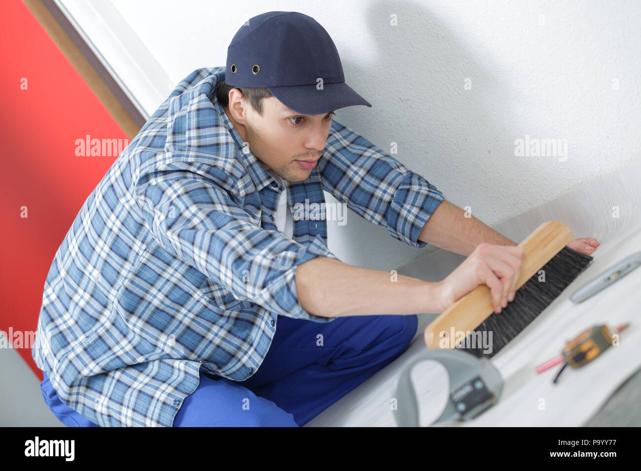 floor tiles installation man installs ceramic tile Stock Photo - Alamy