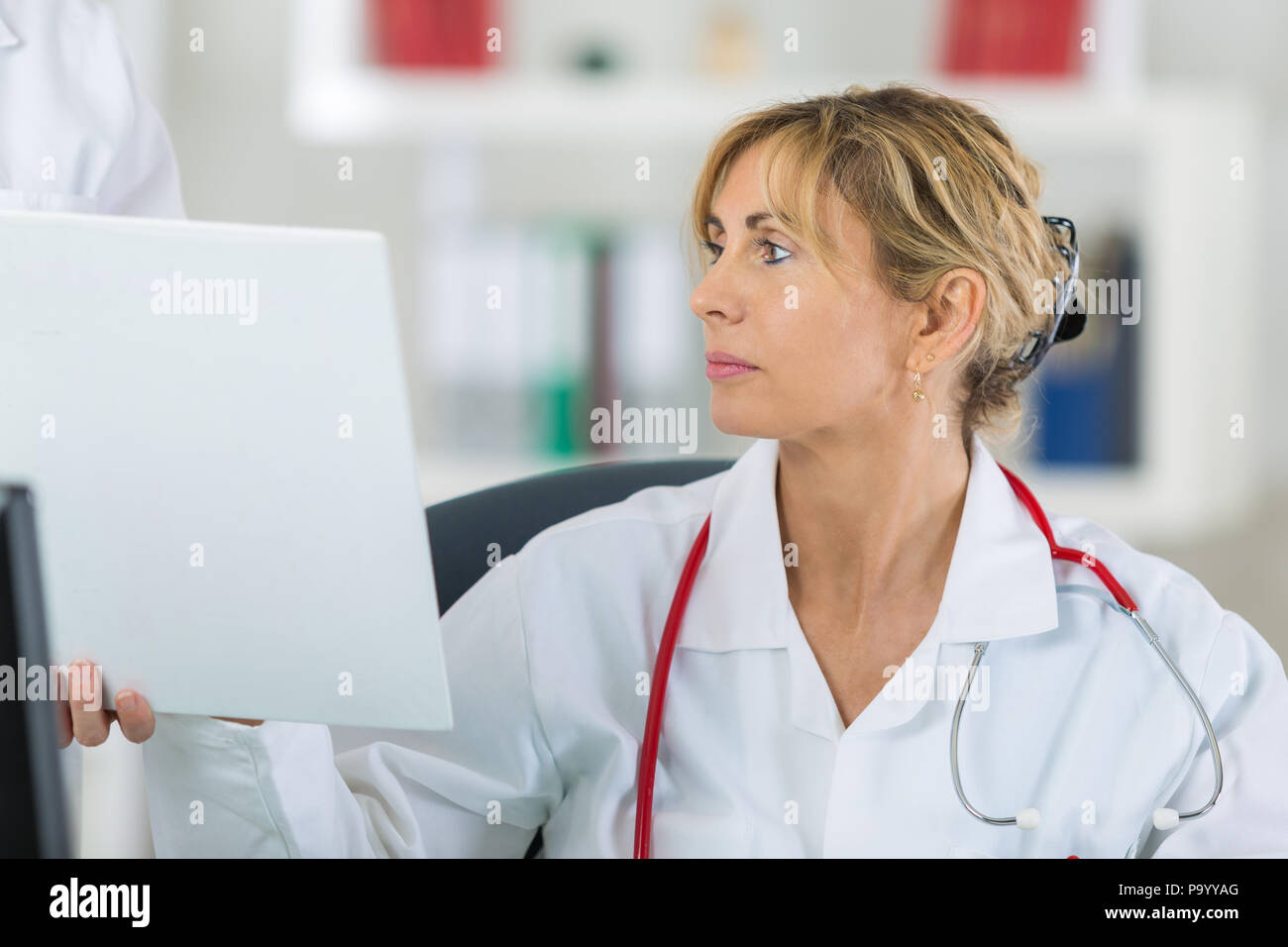 doctor looking for the resemblance of the results Stock Photo - Alamy