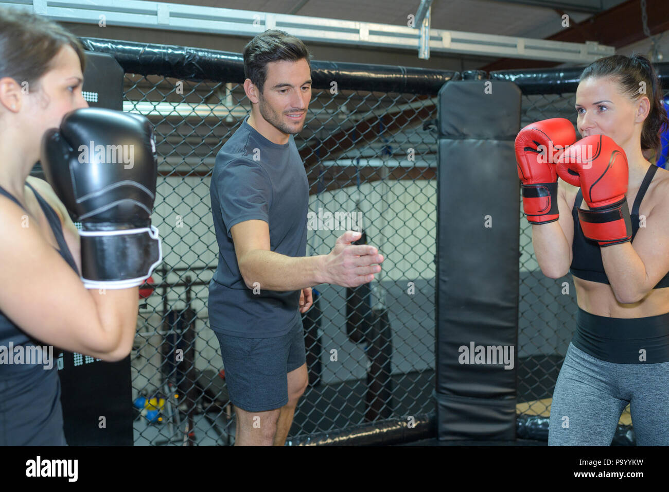 boxing female trainer supervising the boxing students Stock Photo - Alamy