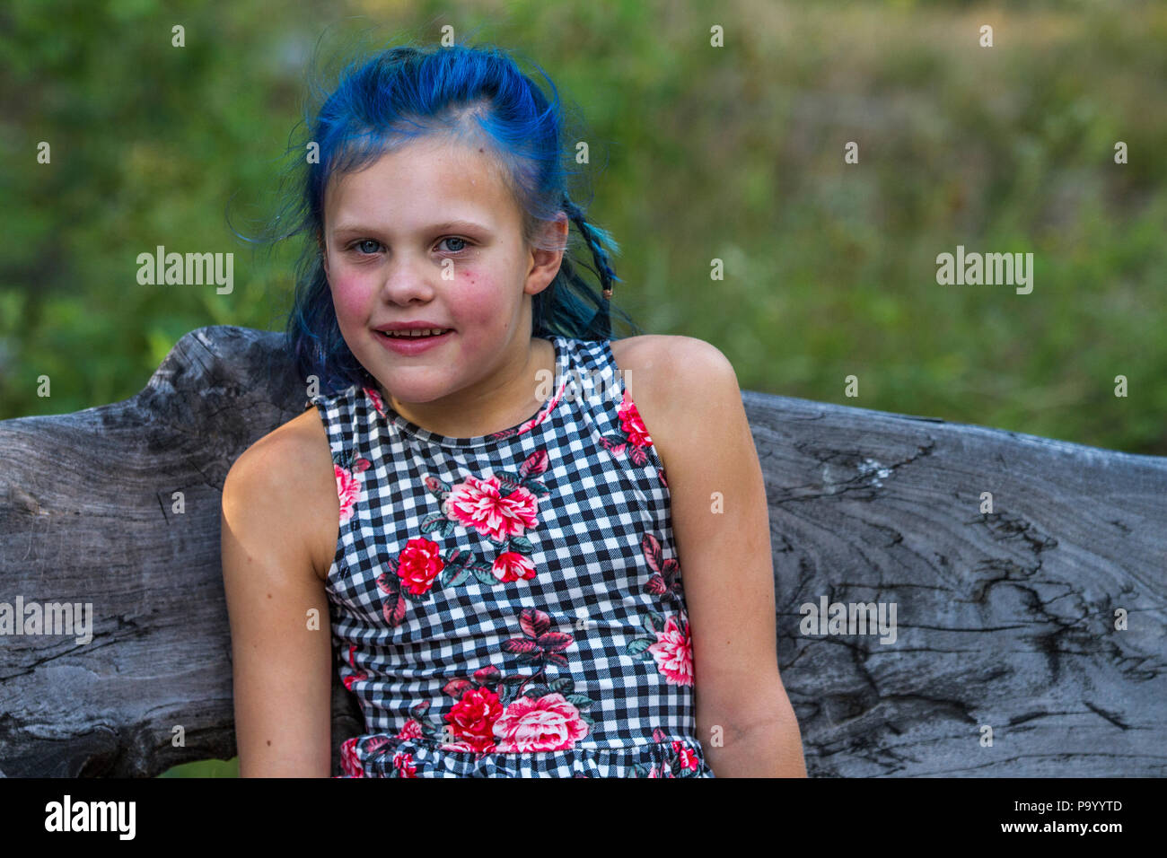 Atrtractive 8 year old girl, in colorful jump suit, hair is dyed bright ...