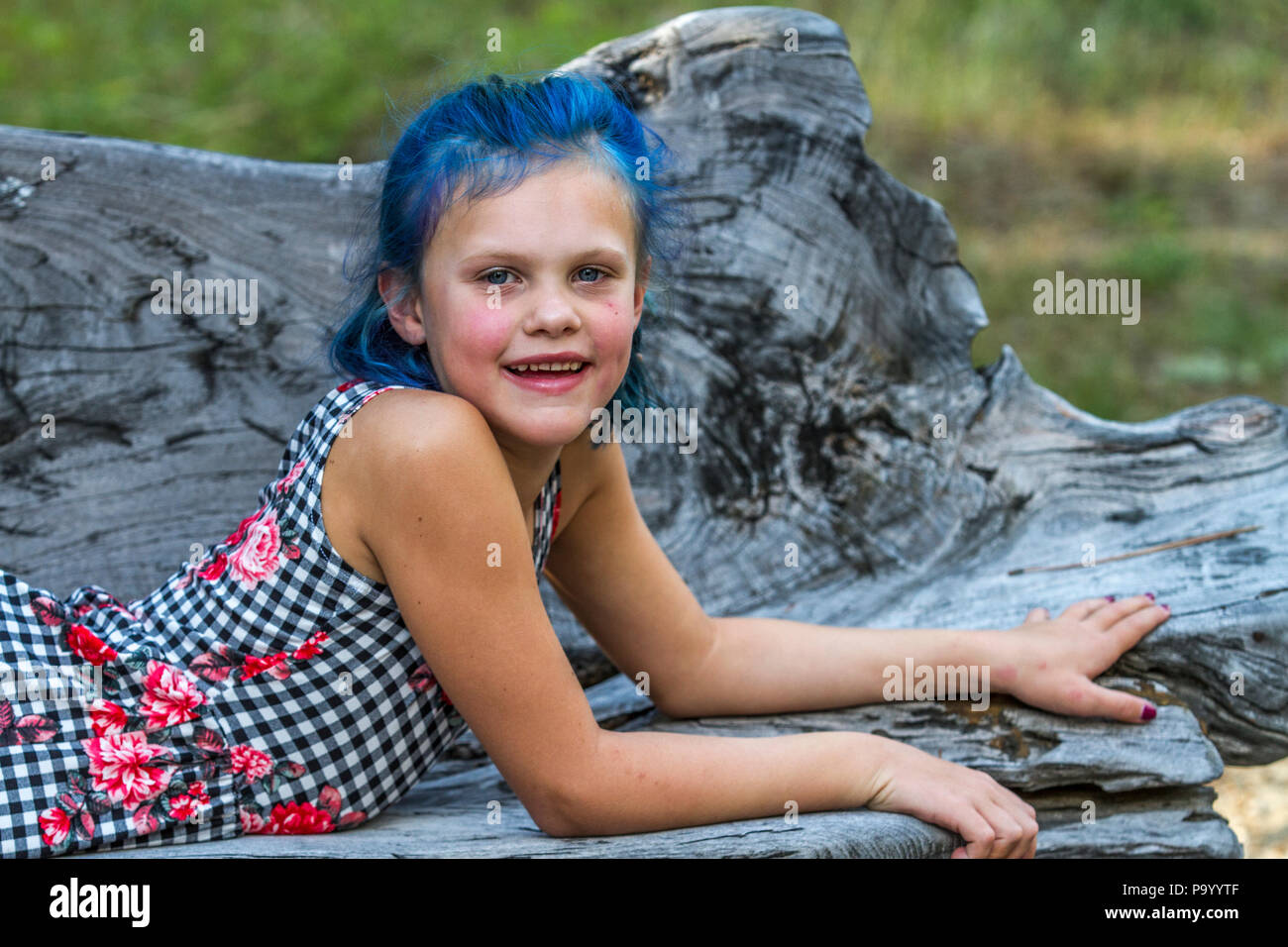 Atrtractive 8 year old girl, in colorful jump suit, hair is dyed bright ...