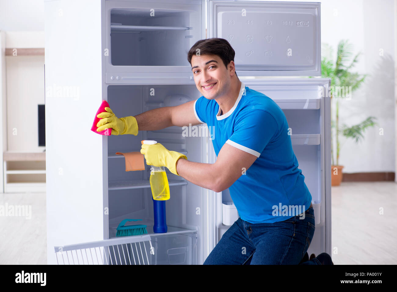 Man cleaning fridge in hygiene concept Stock Photo - Alamy