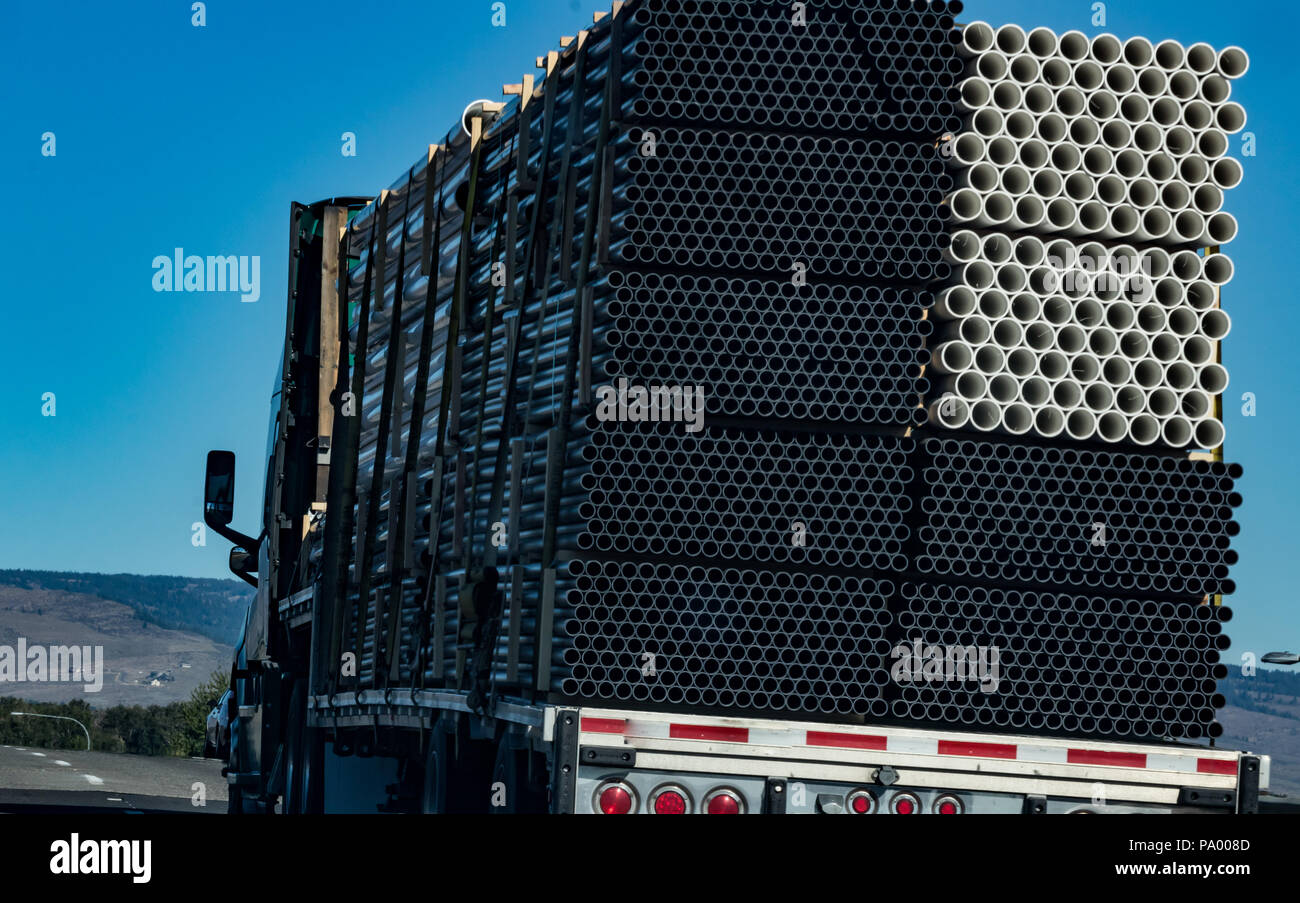 Semi tractor trailer hauling pvc pipe conduit with a shadow Stock Photo ...