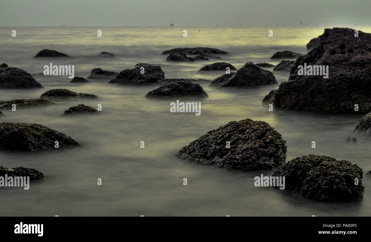 Rocks on the beach side in calm arabian sea looks like floating rocks ...