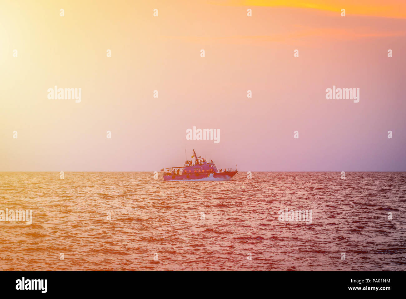 Sailing through sunlight the sea in evening Stock Photo - Alamy