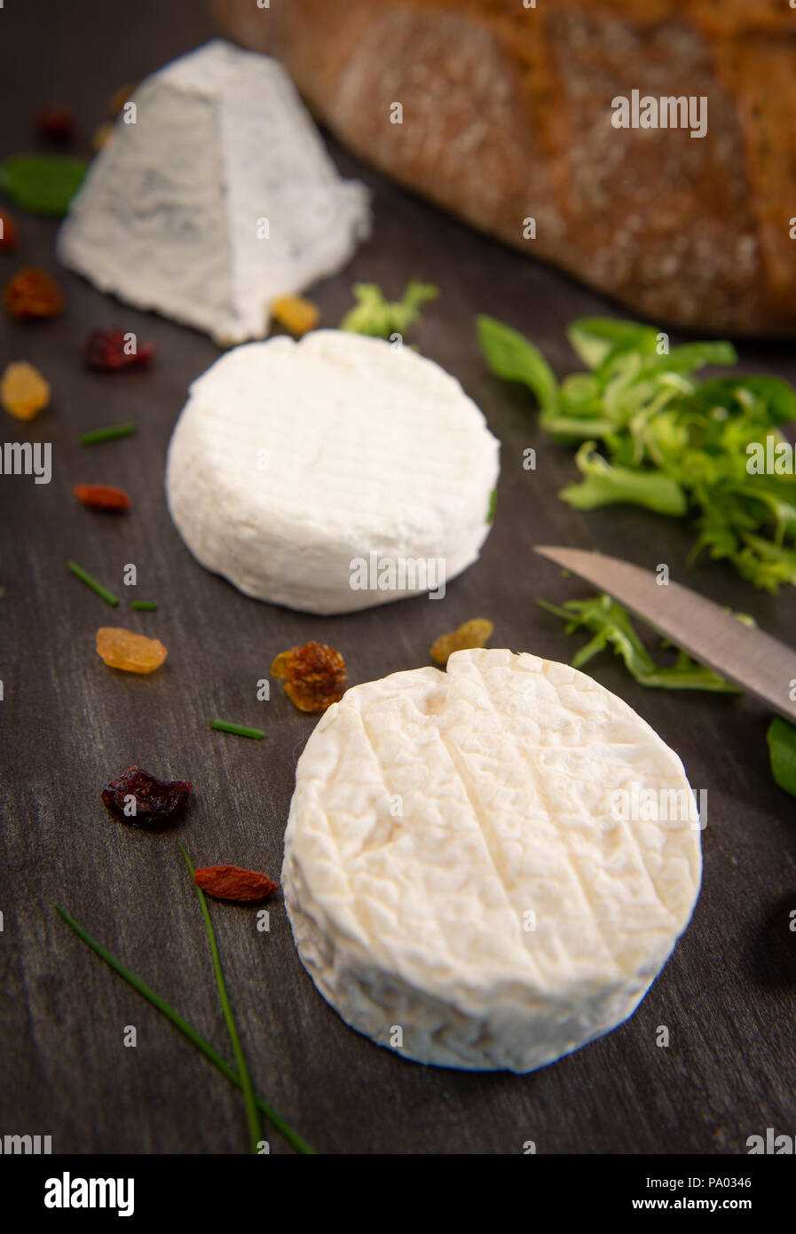 French goats cheeses and bread on background, France Stock Photo - Alamy