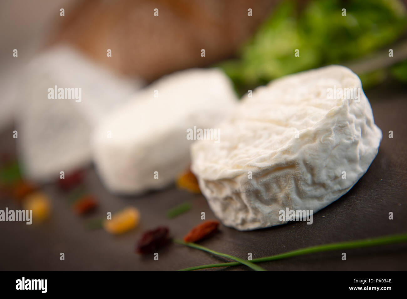 French goats cheeses and bread on background, France Stock Photo - Alamy