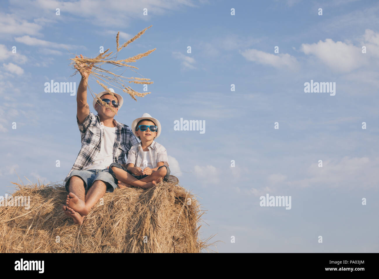 Father and son playing in the park at the day time. People having fun ...