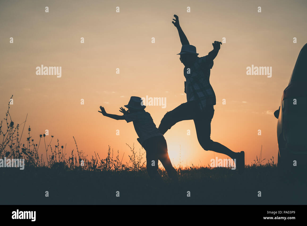 Father And Son Playing In The Park At The Sunset Time People Having