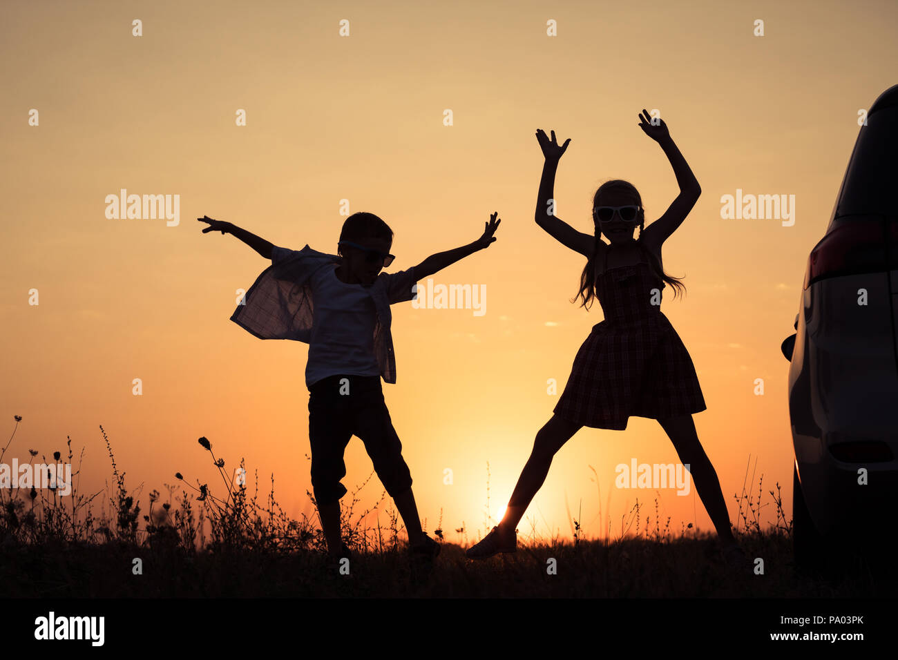 Happy children playing in the park at the sunset time. People having ...