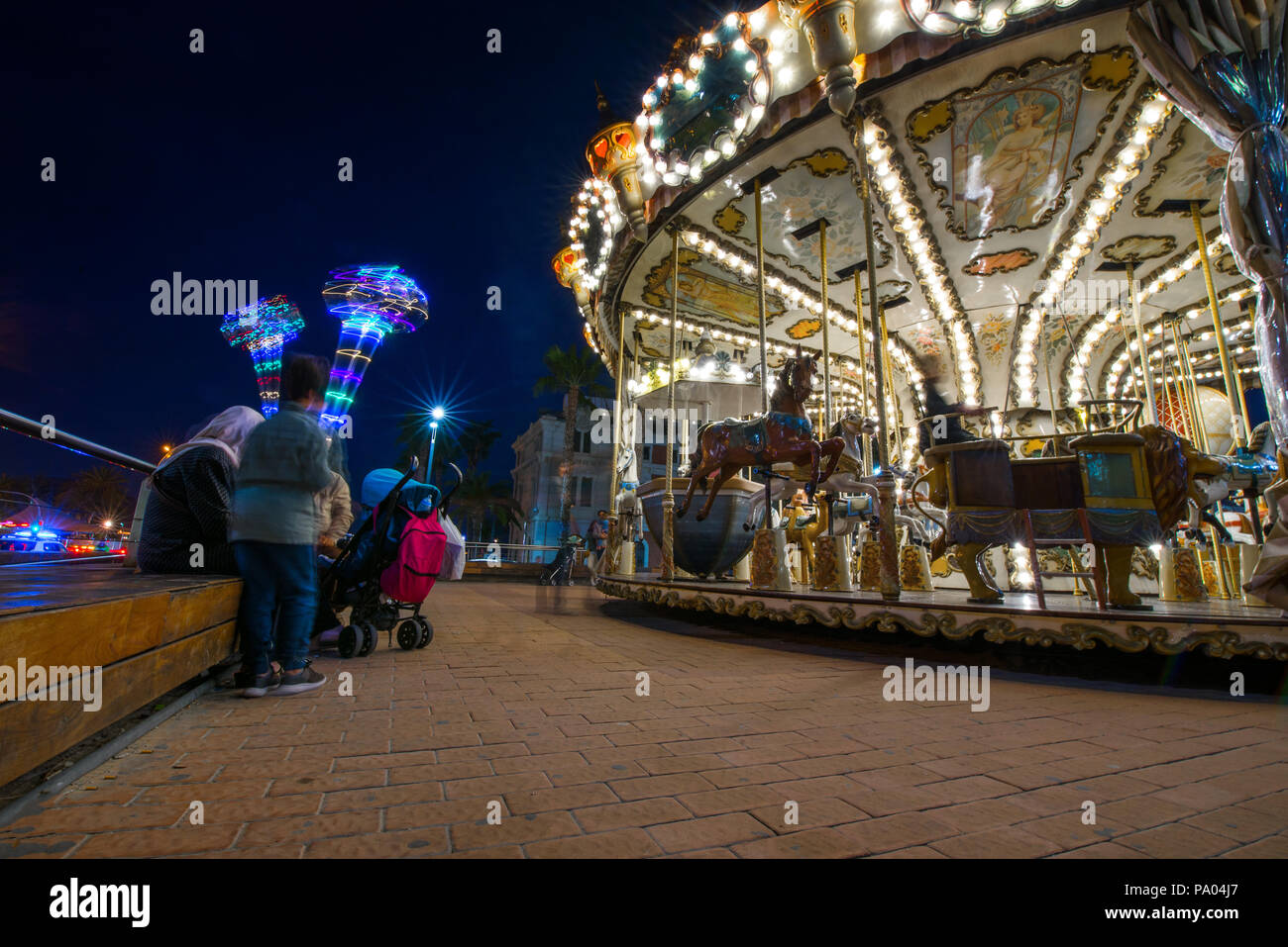 Children's vintage Carousel at an amusement park in the evening and ...