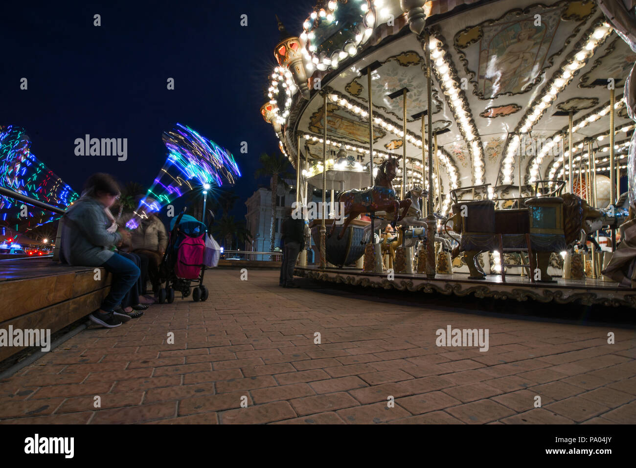 Children's vintage Carousel at an amusement park in the evening and ...