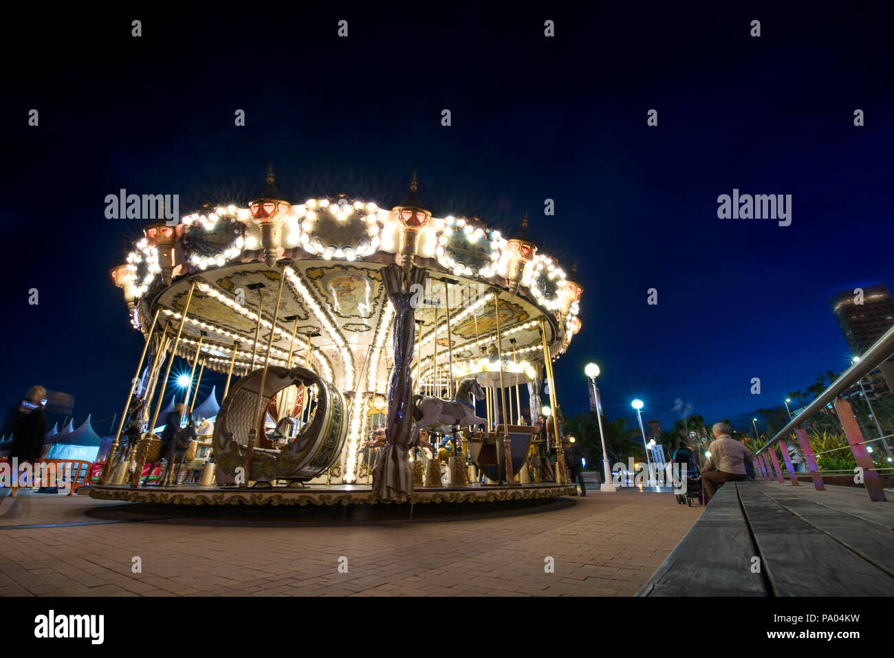 Children's vintage Carousel at an amusement park in the evening and ...