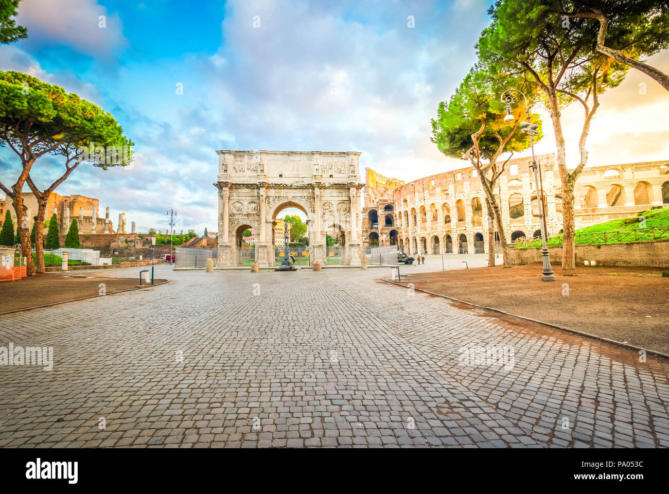 Arch of Constantine and Colosseum with empty alley road, antique Rome ...