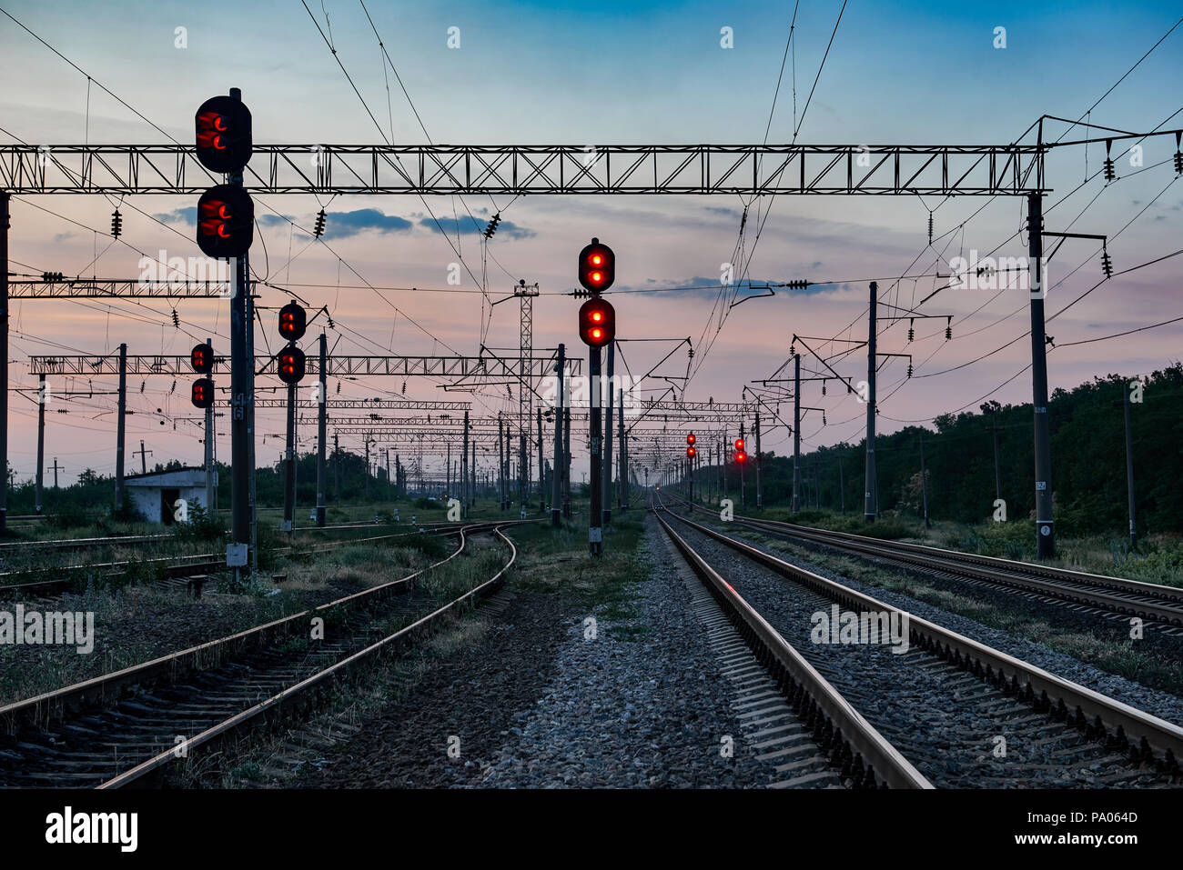 railroad traffic lights and infrastructure during beautiful sunset ...