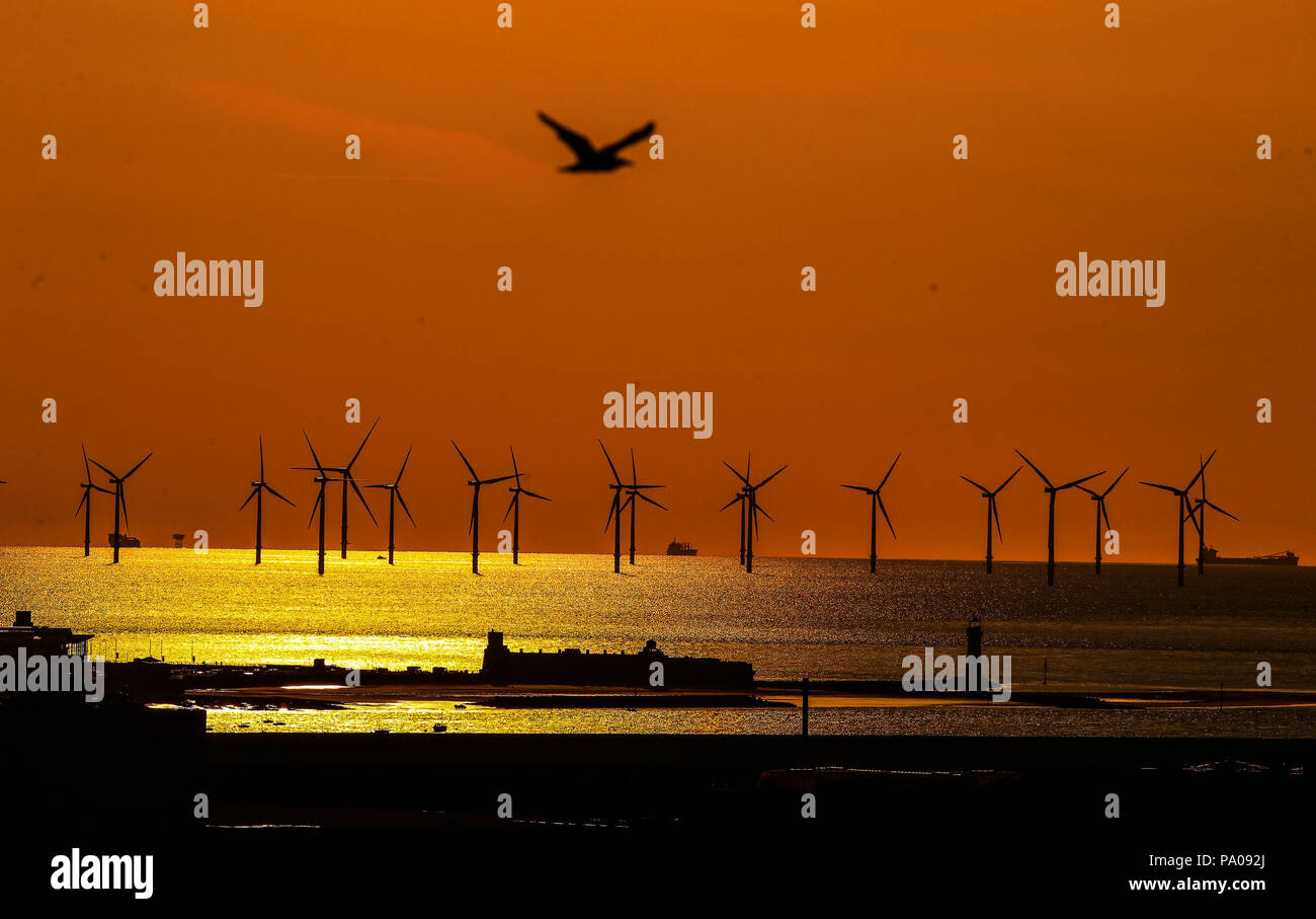 The sun sets over The Burbo Bank Offshore Wind Farm on the River Mersey ...