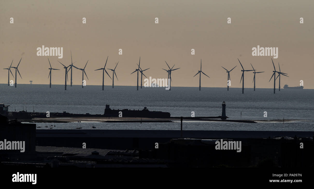 The sun sets over The Burbo Bank Offshore Wind Farm on the River Mersey ...