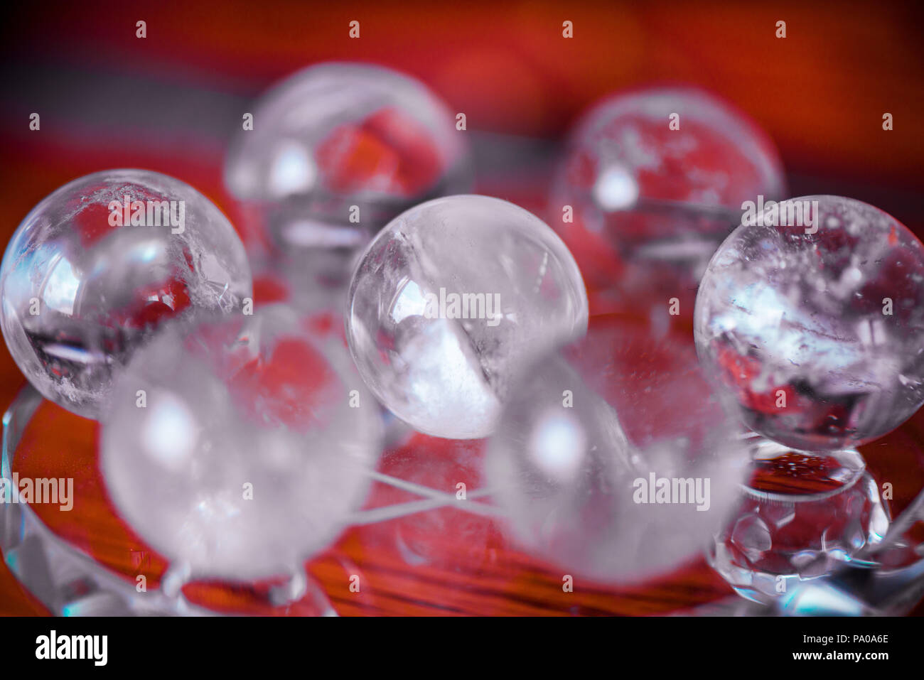 Macro shot of transparent crystal balls with colorful ornaments and sun ...