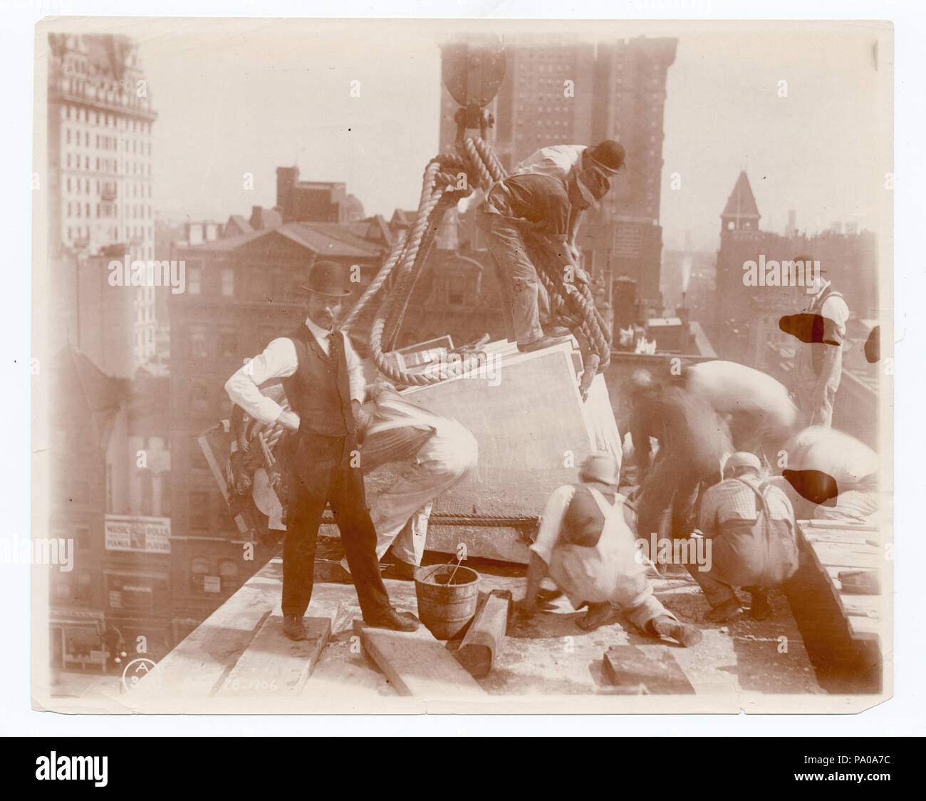 633 Exterior marble work - construction workers positioning a piece of ...