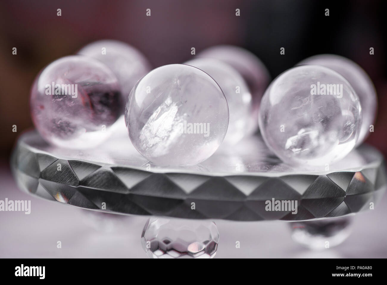 Macro shot of transparent crystal balls with colorful ornaments and sun ...