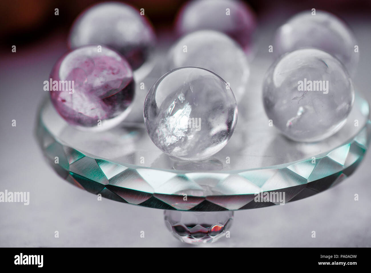 Macro shot of transparent crystal balls with colorful ornaments and sun ...
