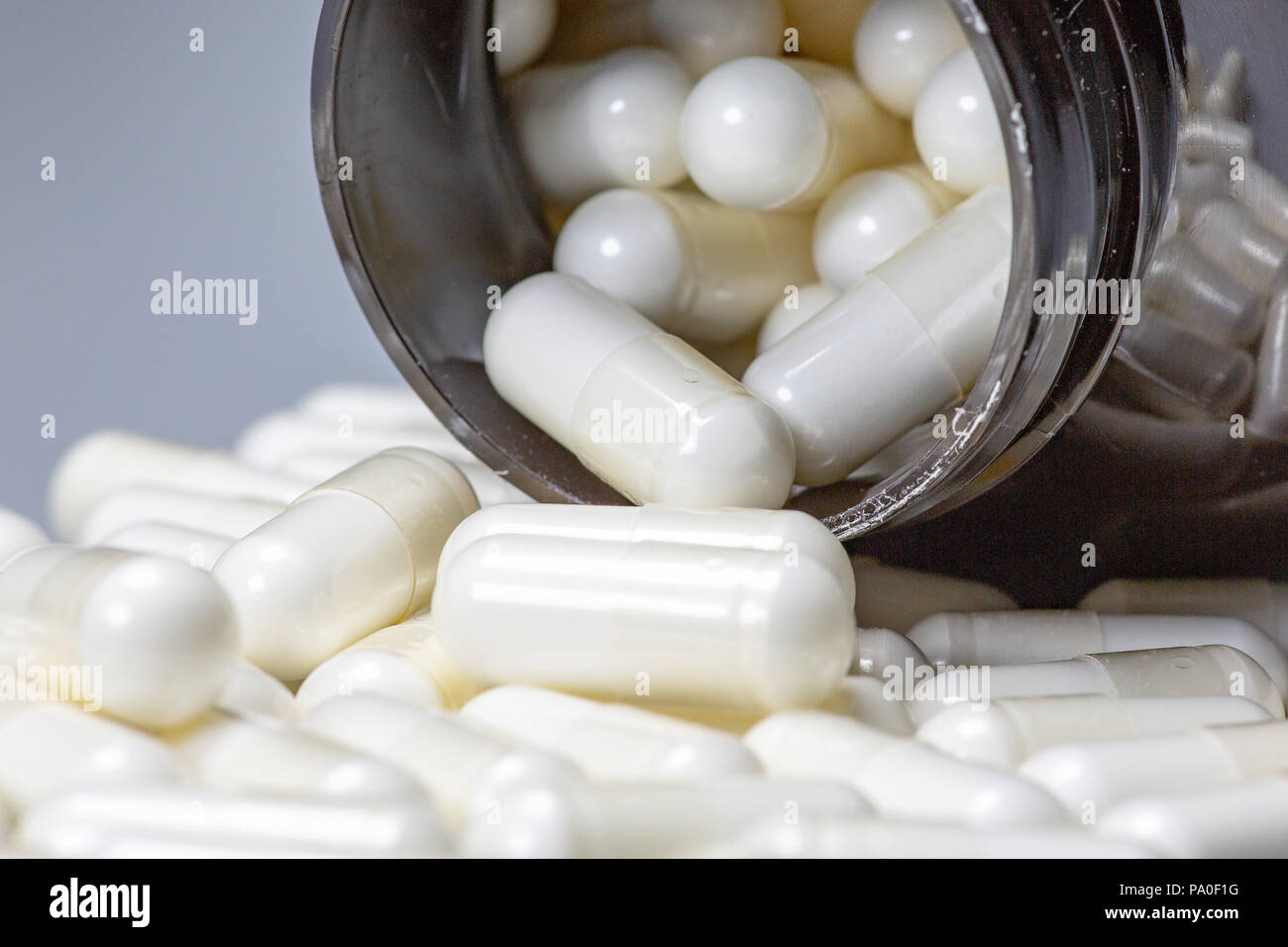 Drug capsules falling out of prescription bottle hi-res stock ...