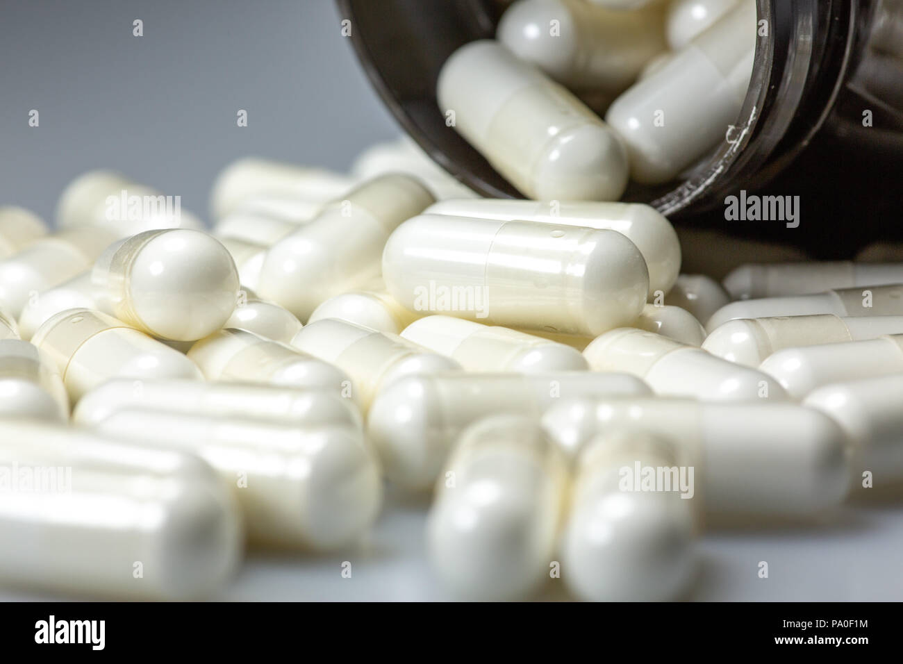 Drug capsules falling out of prescription bottle hi-res stock ...