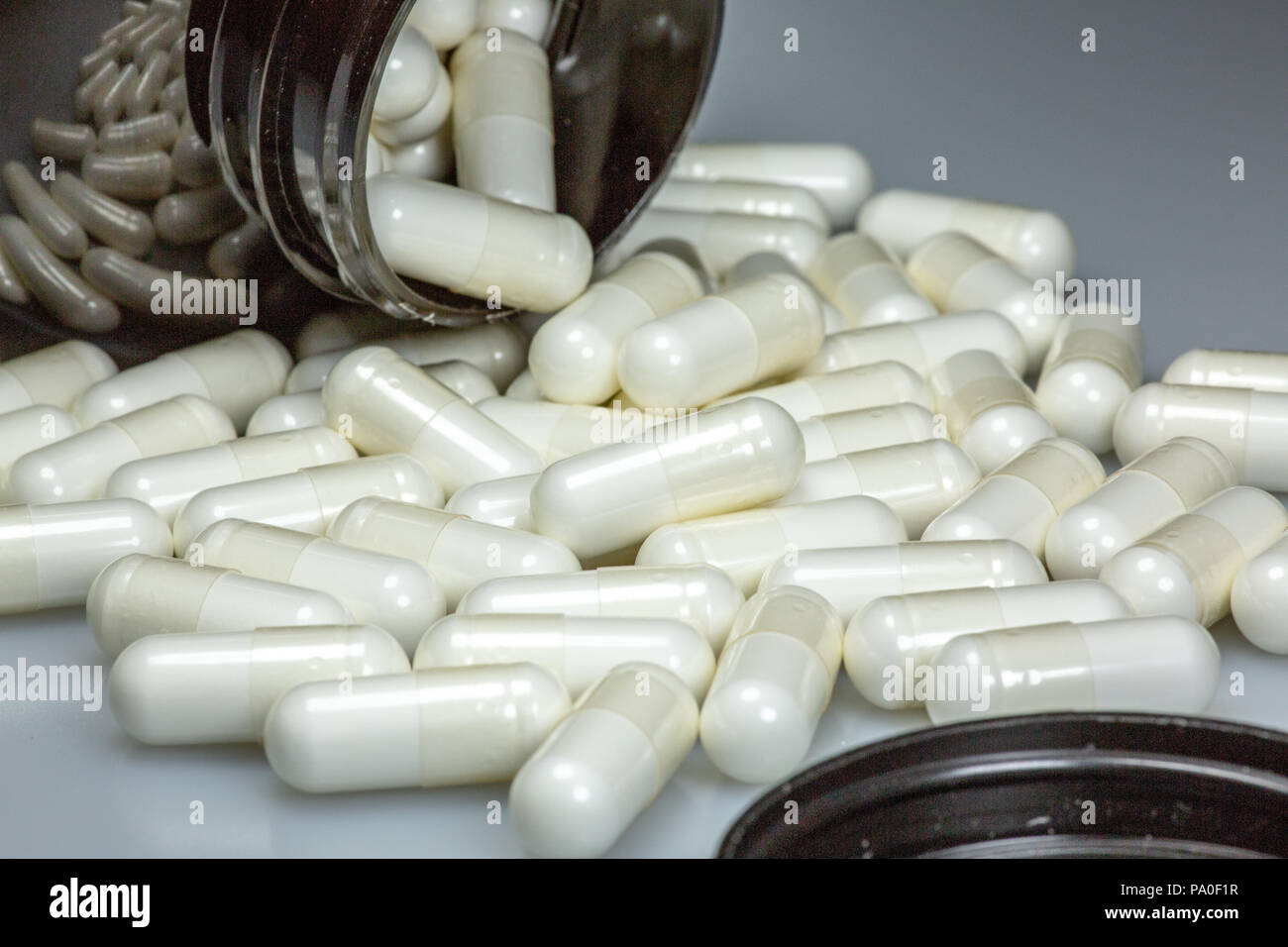 Drug capsules falling out of prescription bottle hi-res stock ...