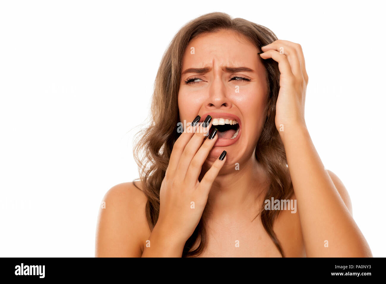 Portrait of beautiful young crying woman on white background Stock ...