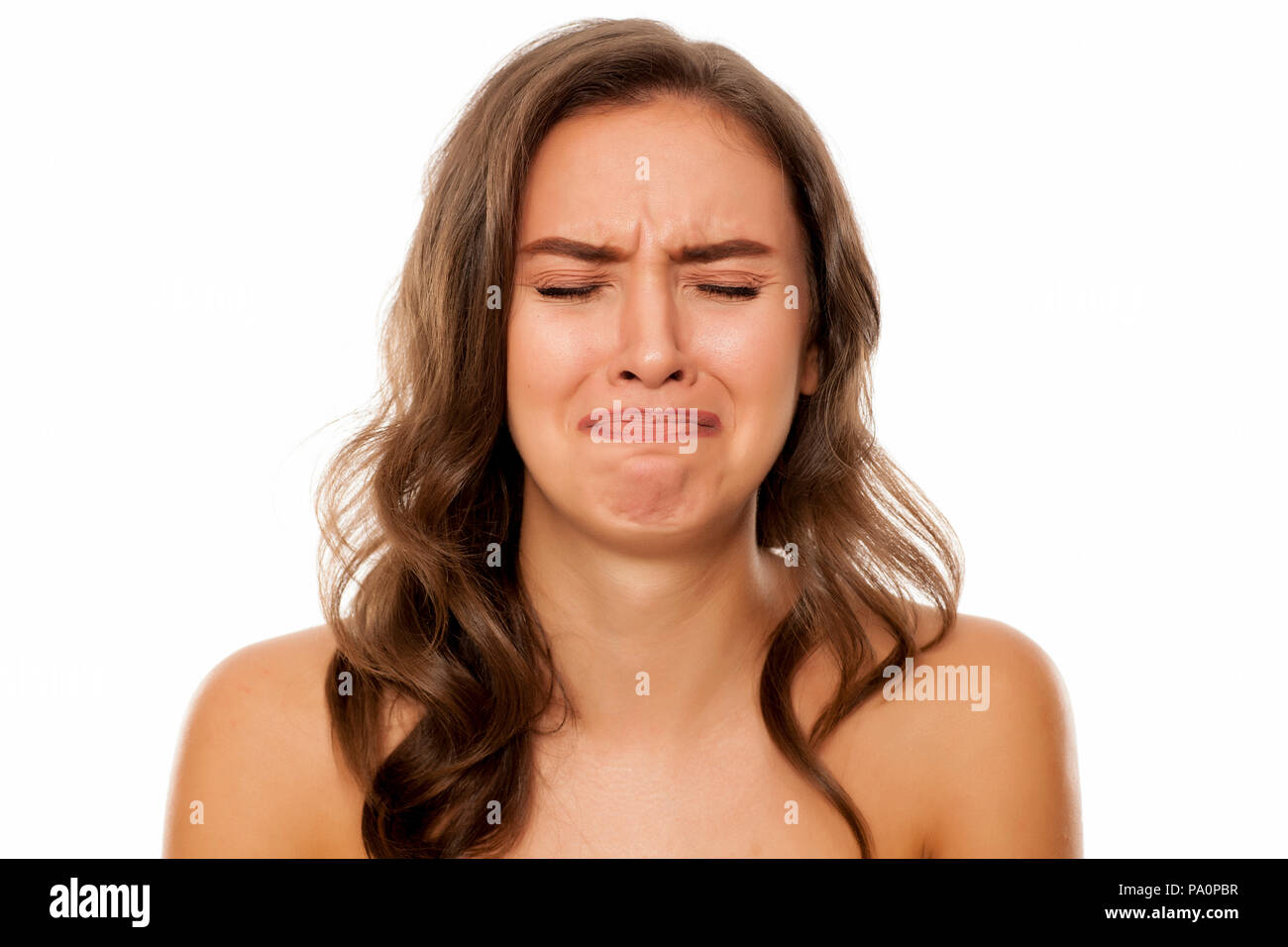 Portrait of beautiful young crying woman on white background Stock ...